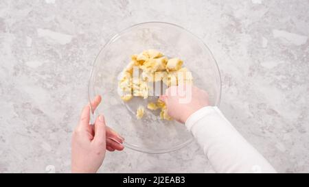 Flat lay. Step by step. Smashing riped bananas in a glass mixing bowl ...