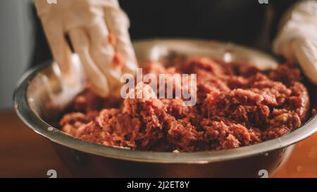 A view of human hands mixing minced meat in kitchen Stock Photo - Alamy