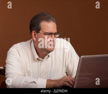 Middle age business man working with computer laptop looking to side ...