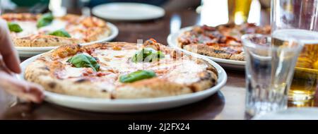 Horizontal banner or header with waiter serving delicious pizzas ...