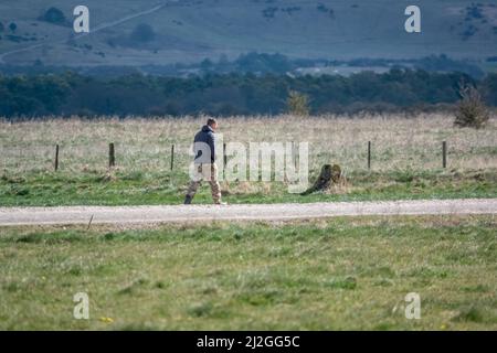 man walking at speed along an unmade track road, hiking, fitness Stock ...