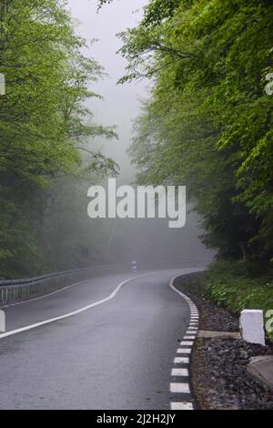 A closeup of an empty road with fogs Stock Photo - Alamy