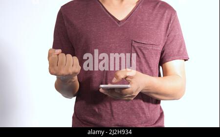 a tall man standing happily using a smartphone On a white isolated ...