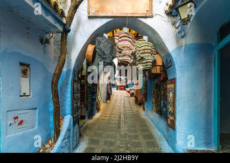 Morocco, Chefchaouen, Cobblestone alley and souvenirs for sale Stock ...