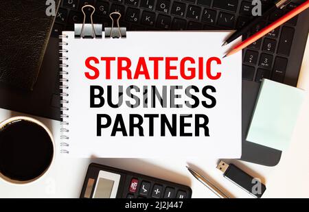 Strategic business partner text on paper on the chart background with ...