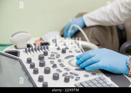 gynecologist doctor prepares an ultrasound machine for the diagnosis of ...