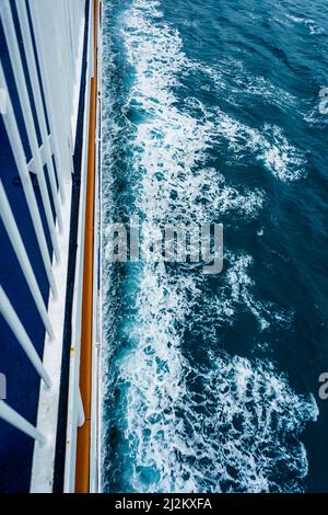 The waves hitting the side of a boat sailing on the water Stock Photo ...