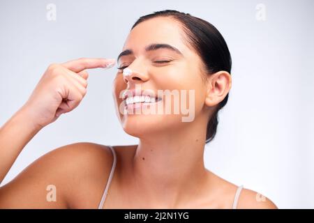 Dont leave your skin high and dry. Shot of a beautiful young woman ...