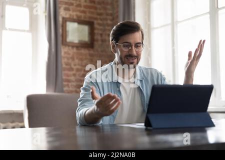 Engaged online teacher, coach giving workshop, webinar, using laptop ...