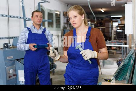 Female glazier measuring glass with caliper Stock Photo - Alamy