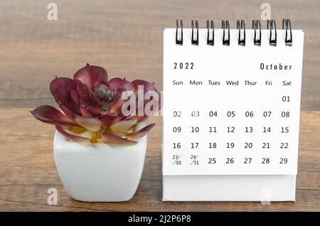 October 2022 desk calendar with plant on wooden table Stock Photo - Alamy