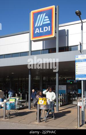 Aldi sign at the entrance to the car park of a large Aldi supermarket ...