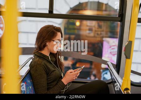 This bus takes me everywhere. High angle portrait of an attractive ...