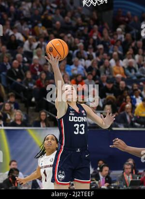 UConn guard Caroline Ducharme, center, makes a passing assist between ...