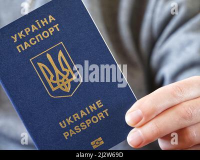 A citizen of Ukraine shows his biometric passport. Passport in the ...
