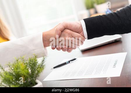 Businesswoman and businessman shaking hands (Lorem ipsum text used ...