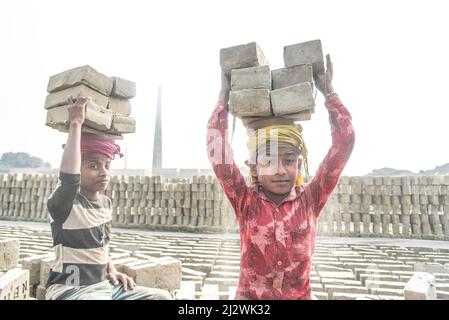 Children carrying heavy bricks in rural Madagascar Stock Photo - Alamy