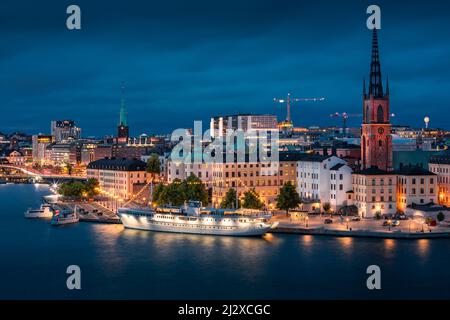 Illuminated skyline of Stockholm at night with Riddarholmskyrkan church ...