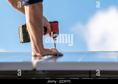 Unidentified man attaching solar panel to the roof rack with the ...