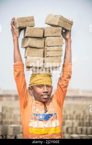 Child workers carry bricks carrying it on his head in Sonakhali, West ...