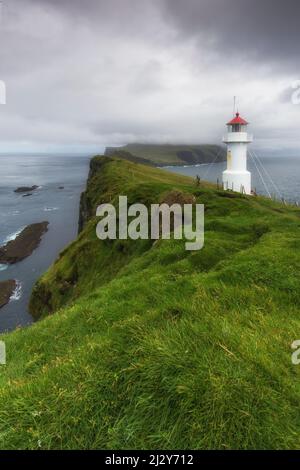 View of cliffs and Mykines Holmur Lighthouse up to Mykines, Faeroe ...