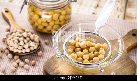 chickpeas being sieved to extract aquafaba, cooking liquid used as an ...