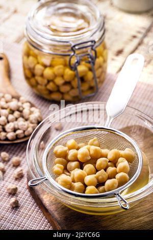 chickpeas being sieved to extract aquafaba, cooking liquid used as an ...
