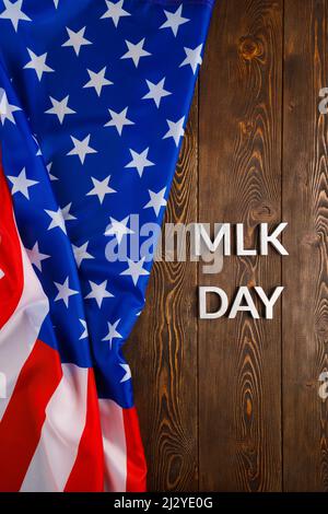 the word MLK day laid with silver metal letters on wooden surface with ...