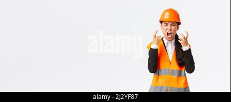 Mad and outraged asian female chief engineer, construction manager ...