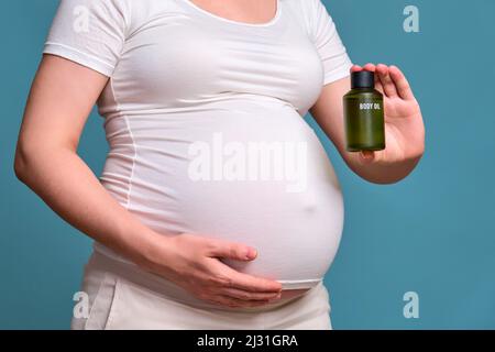 Body oil for pregnant woman, studio shot on white background Stock ...