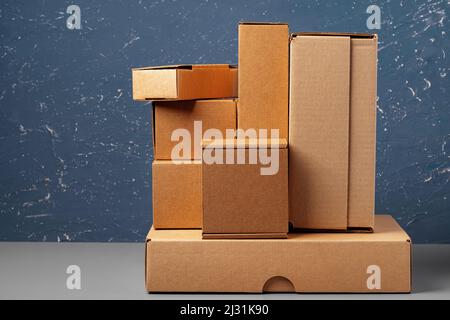 Group of cardboard boxes against blue background Stock Photo - Alamy
