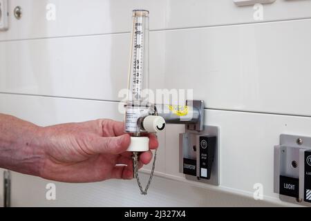 Netherlands, nurse in a hospital is adjusting the oxygen gas for a ...