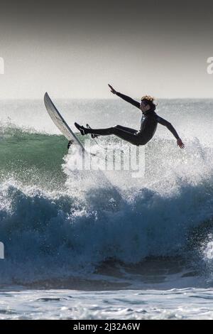 A surfer losing balance and wiping out at Fistral in Newquay in ...