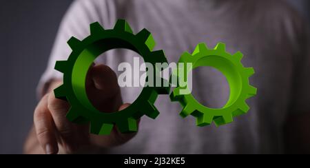 3d rendered green metallic gears and cogs in mans hand Stock Photo - Alamy