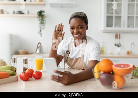 Woman in black apron lunch at home vegetarian food isolated background ...