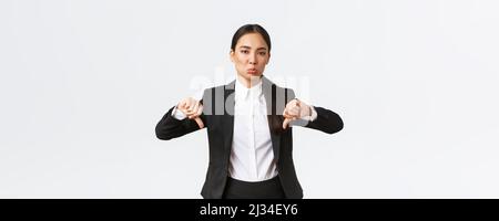 Unamused skeptical female office manager, saleswoman in black suit ...