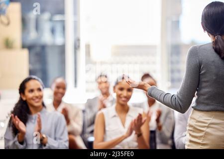 He deserves a round of applause. Shot of a group of cheerful young ...