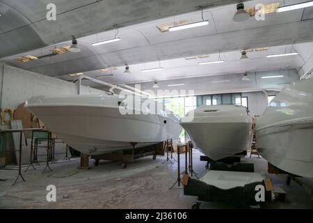 An indoor shipyard of speed boats under construction in Sicily, Italy ...