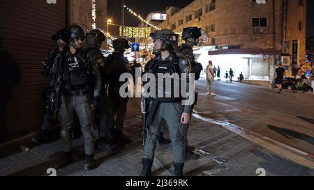 Members of the Israeli forces stand on guard after blocking access for ...