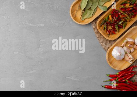 Small bowls with spices on gray background Stock Photo - Alamy