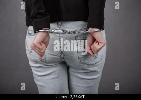 women's hands in handcuffs behind their backs Stock Photo - Alamy