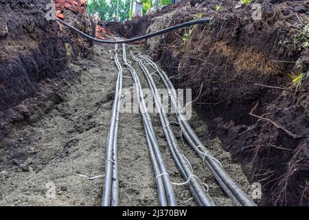 High voltage cables laid in the ground. Laying the electrical cable in ...