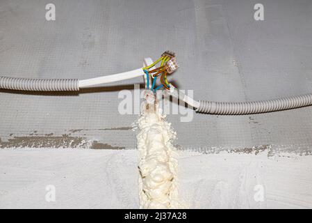 Cable groove filled with mounting foam in the facade of a polystyrene ...