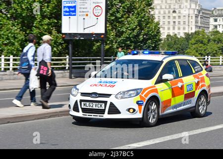 Urgent NHS blood delivery in white Ford car with Battenberg reflective ...