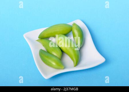 Achocha in a saucer on a blue background Stock Photo - Alamy