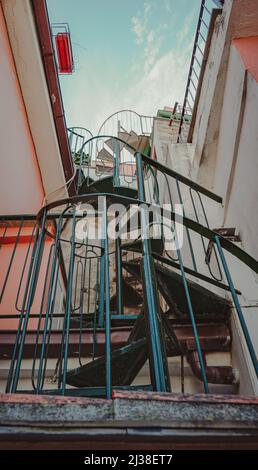 Outdoor stairs between two houses at a parking garage with stores ...