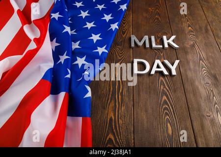 the word MLK day laid with silver metal letters on wooden surface with ...