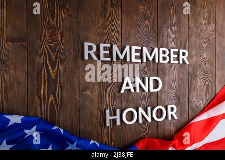 words remember and honor laid with silver metal letters on wooden ...