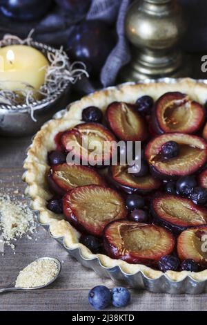 Tasty plum galette on color background Stock Photo - Alamy