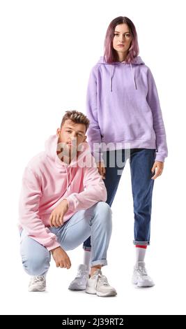 Cool young couple in hoodies on color background Stock Photo - Alamy